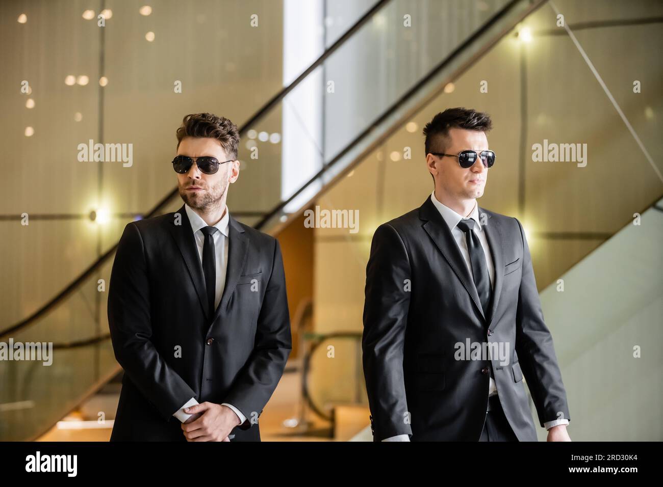 security measures of luxury hotel, two handsome men in formal wear and ...