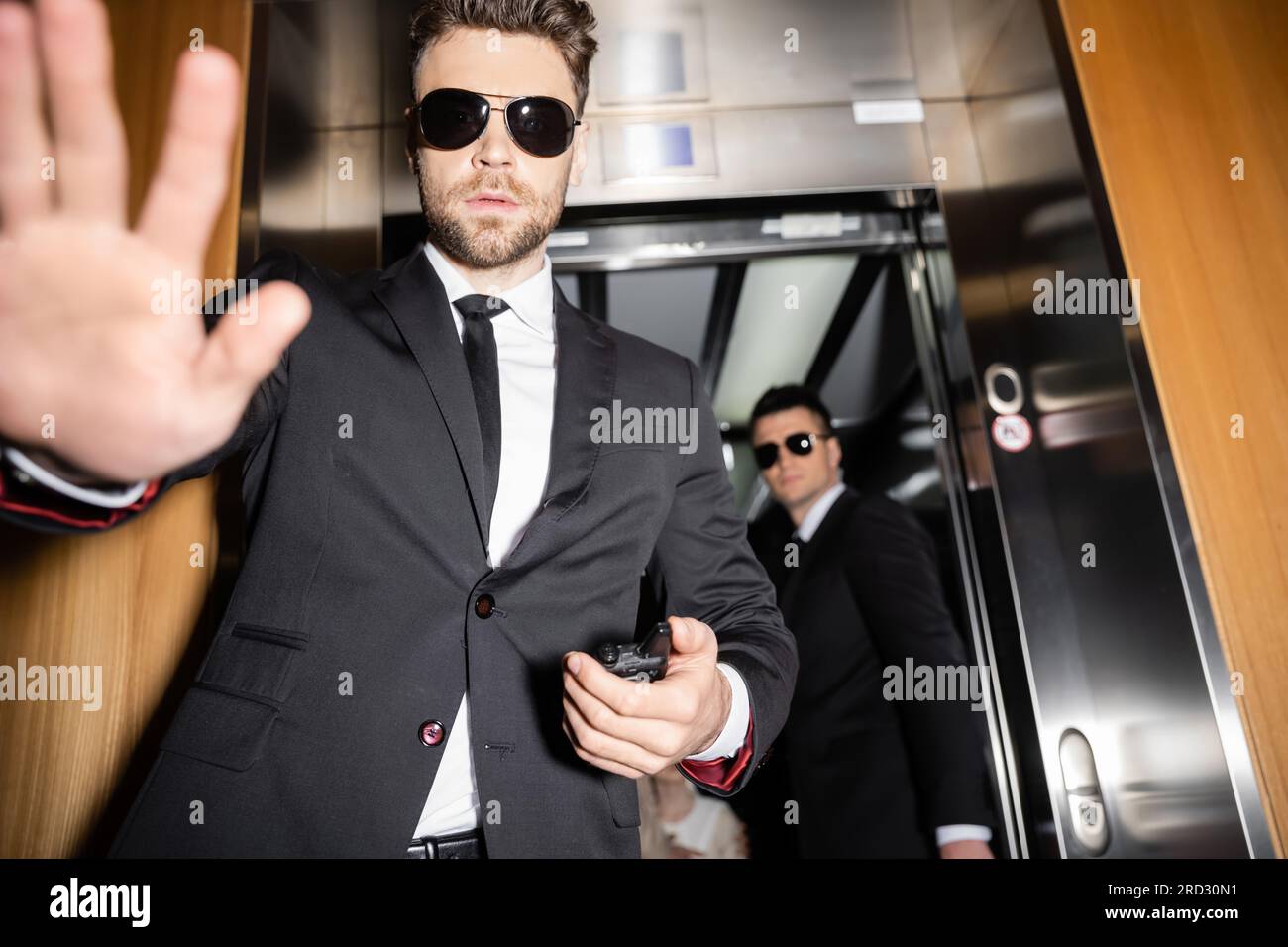 private security concept, handsome bodyguard in sunglasses and suit ...