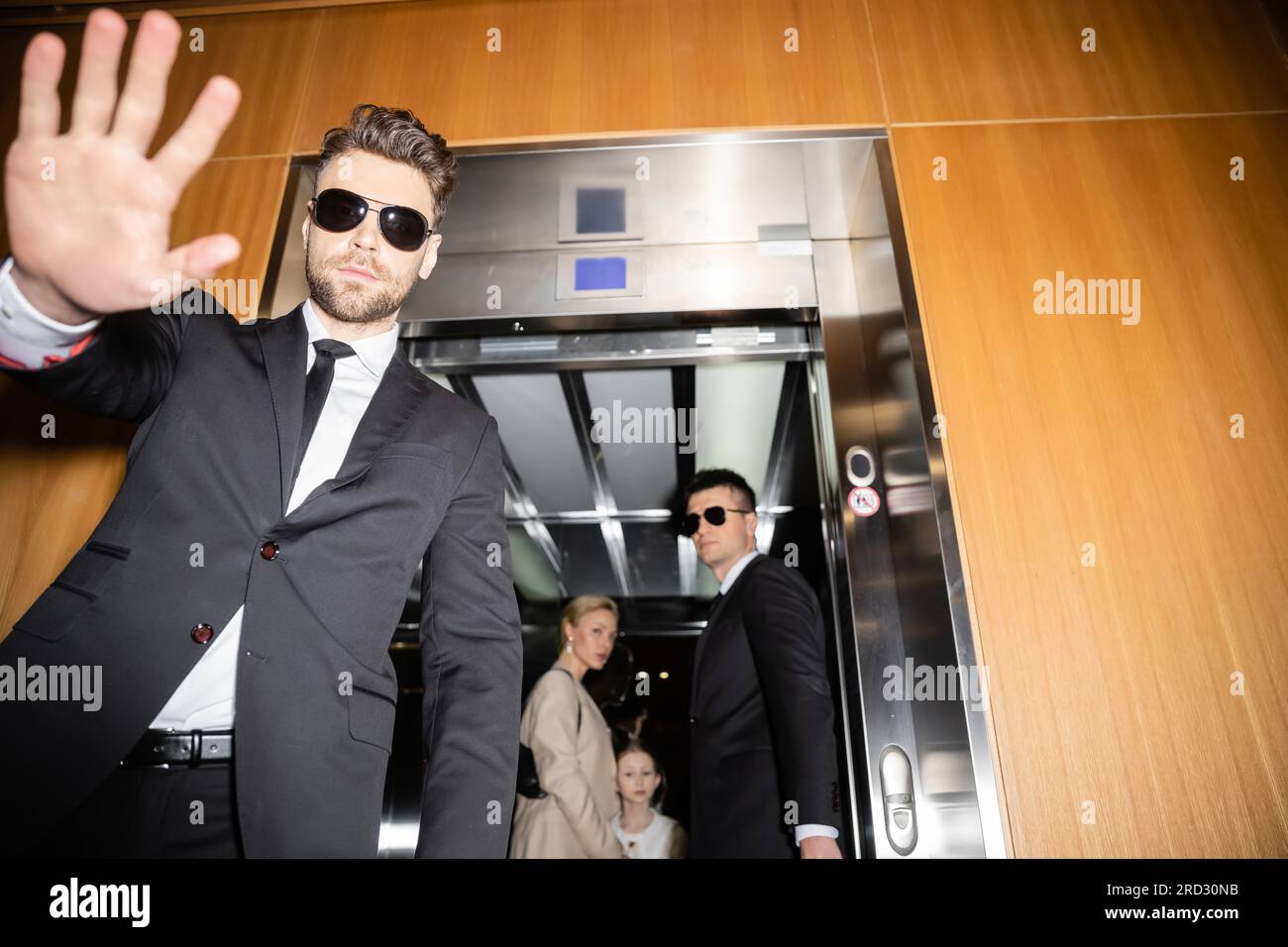 private security concept, handsome bodyguard in sunglasses and suit ...