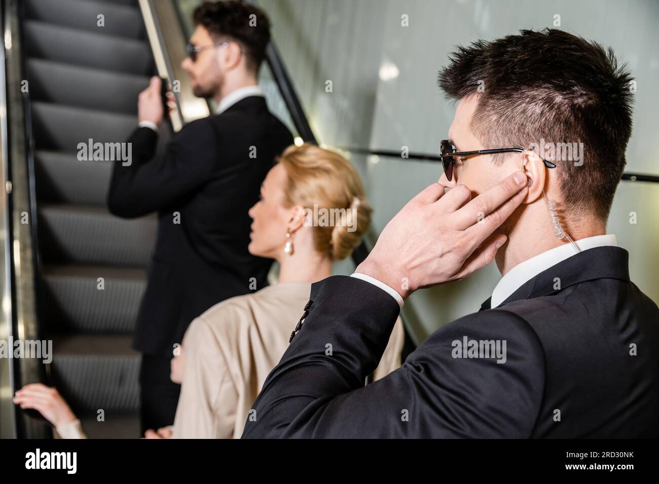 personal security concept, professional bodyguards communicating while ...