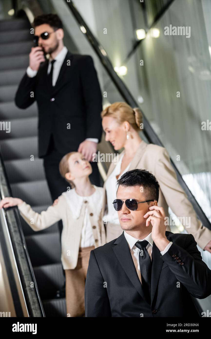 personal security concept, handsome bodyguards communicating while ...