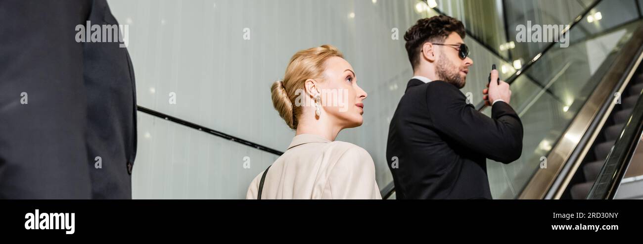 personal security concept, professional bodyguards communicating while ...