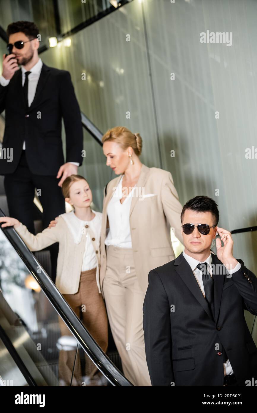 personal security concept, handsome bodyguards communicating while ...