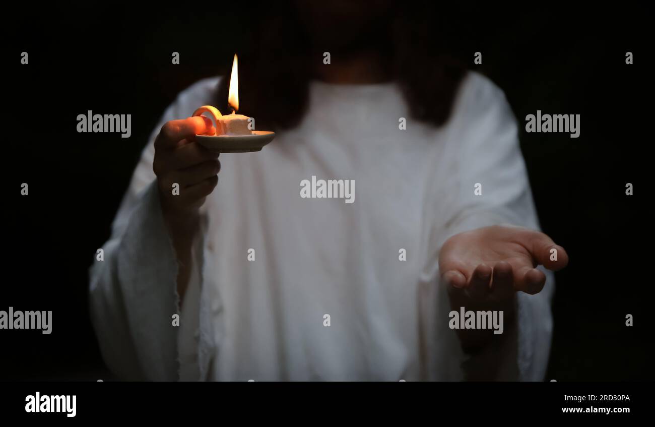 Resurrected Jesus Christ holding a lamp in his hand and extending his ...