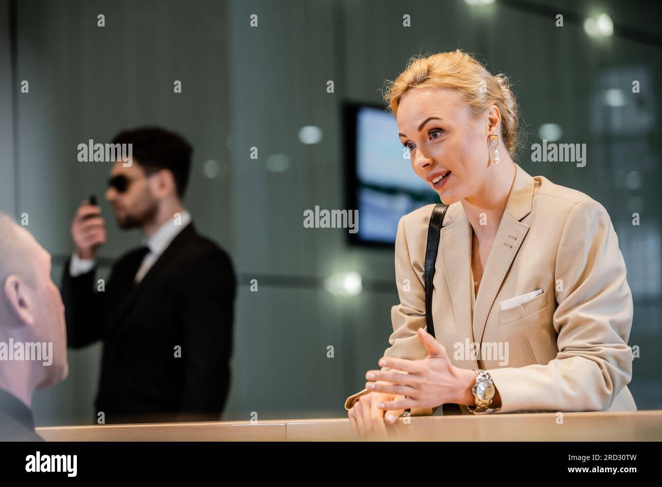 polite businesswoman talking to receptionist in hotel, hospitality ...