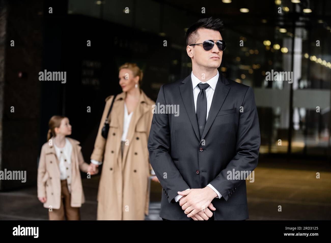 personal security, lifestyle, bodyguard in suit standing near ...