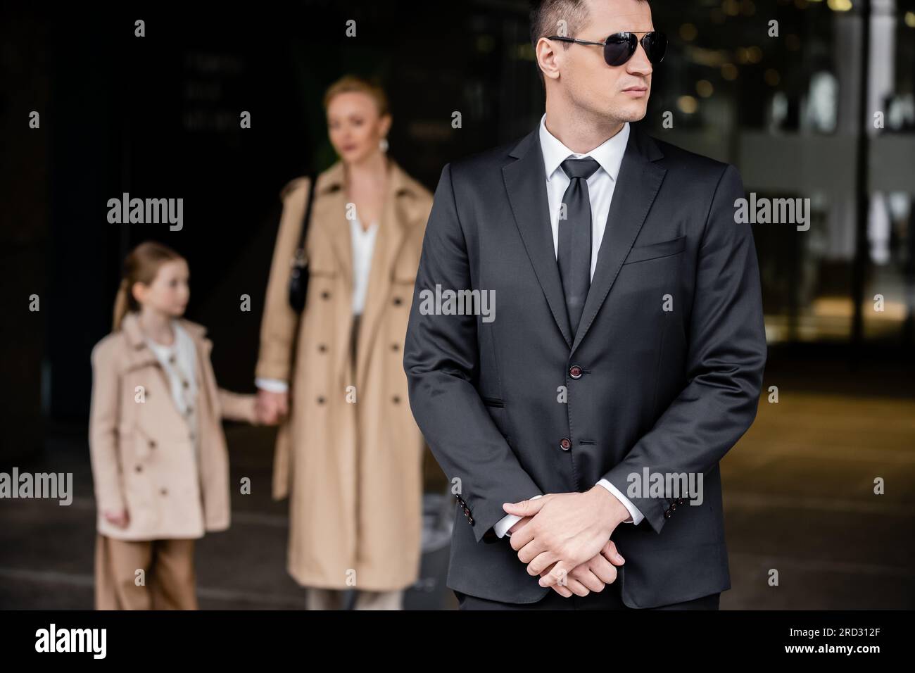 personal security service, lifestyle, bodyguard in suit standing near ...