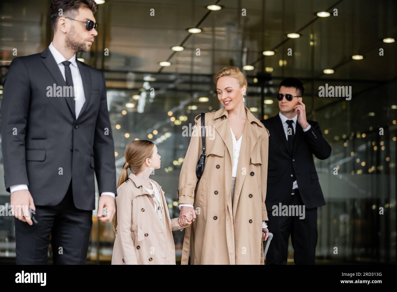 two bodyguards protecting successful woman and preteen kid, private ...