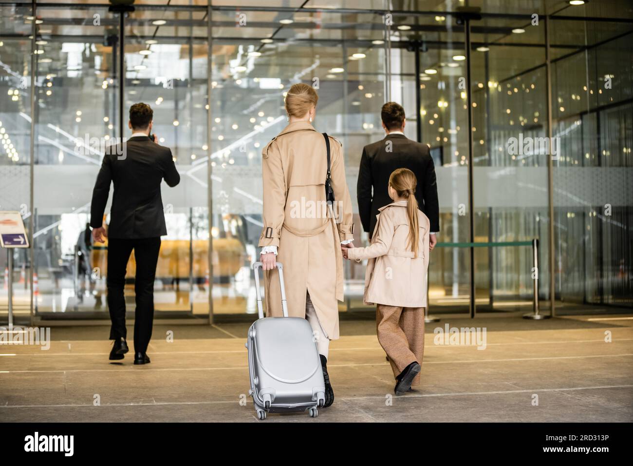 personal security, two bodyguards walking next to blonde woman and ...