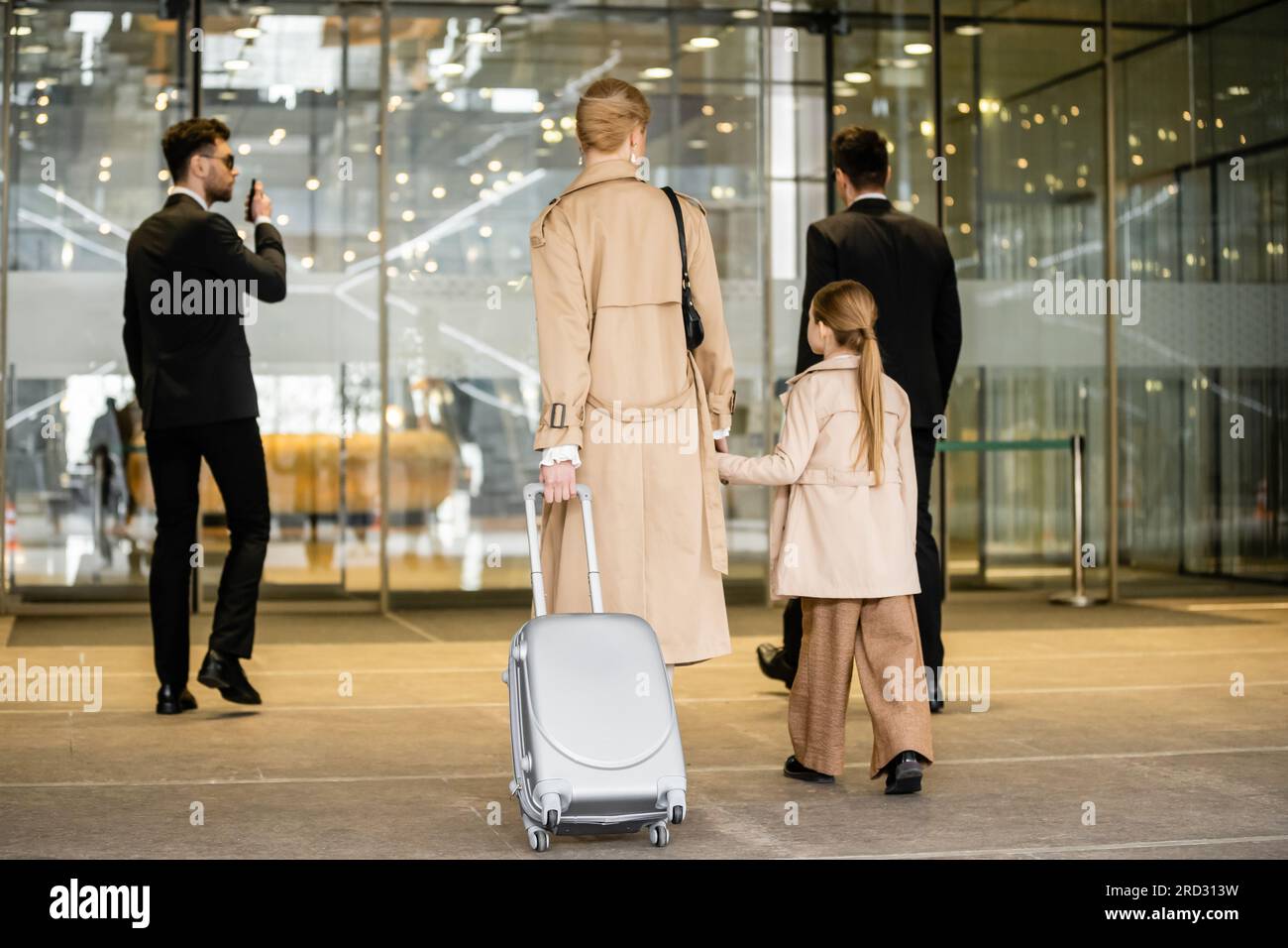personal safety, two bodyguards walking next to blonde woman and ...
