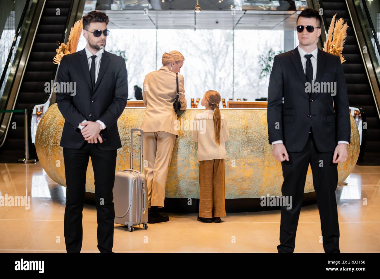 personal security, luxury lifestyle, blonde mother with child standing ...