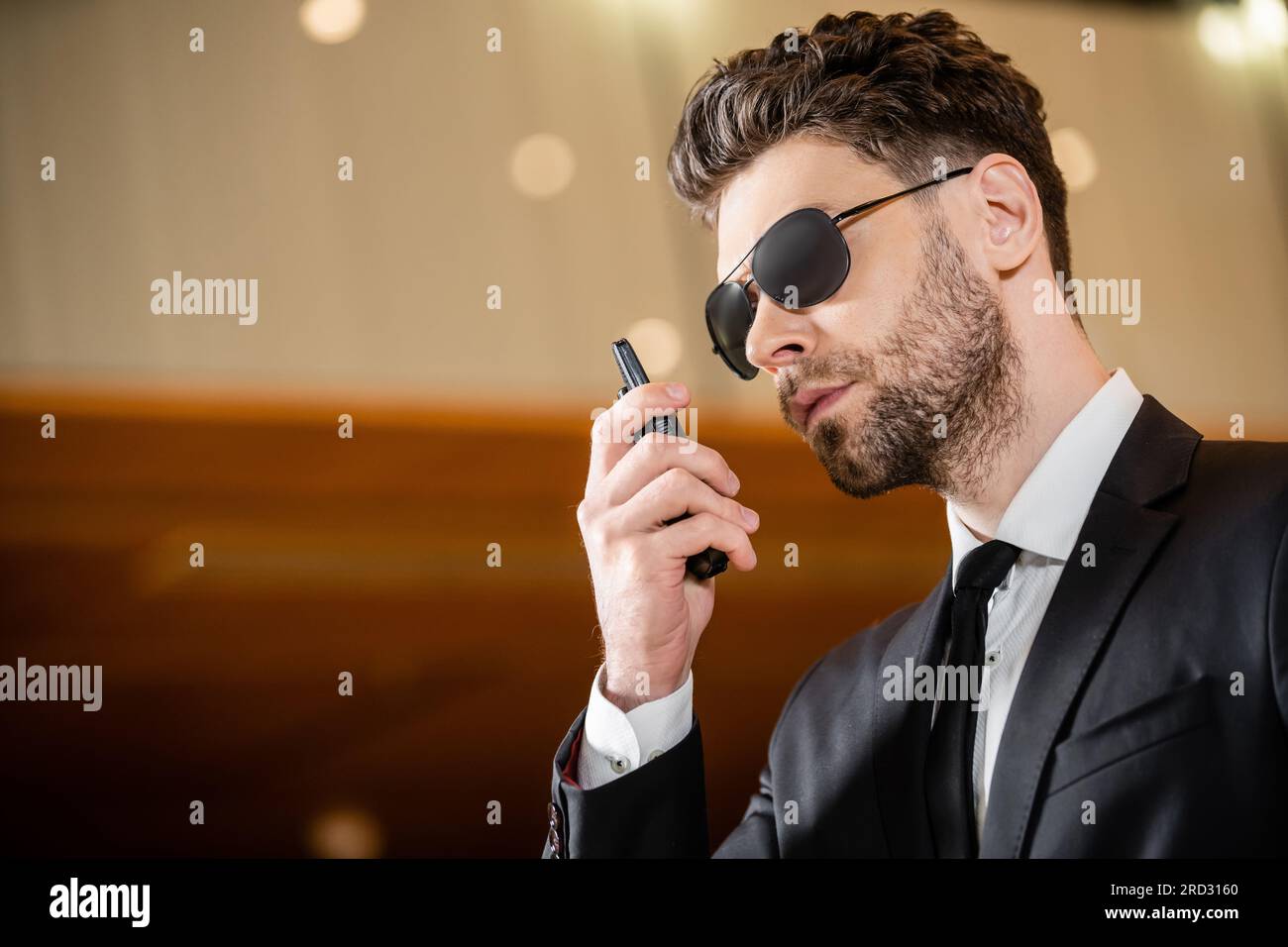 good looking bodyguard, security worker in suit with tie and sunglasses ...