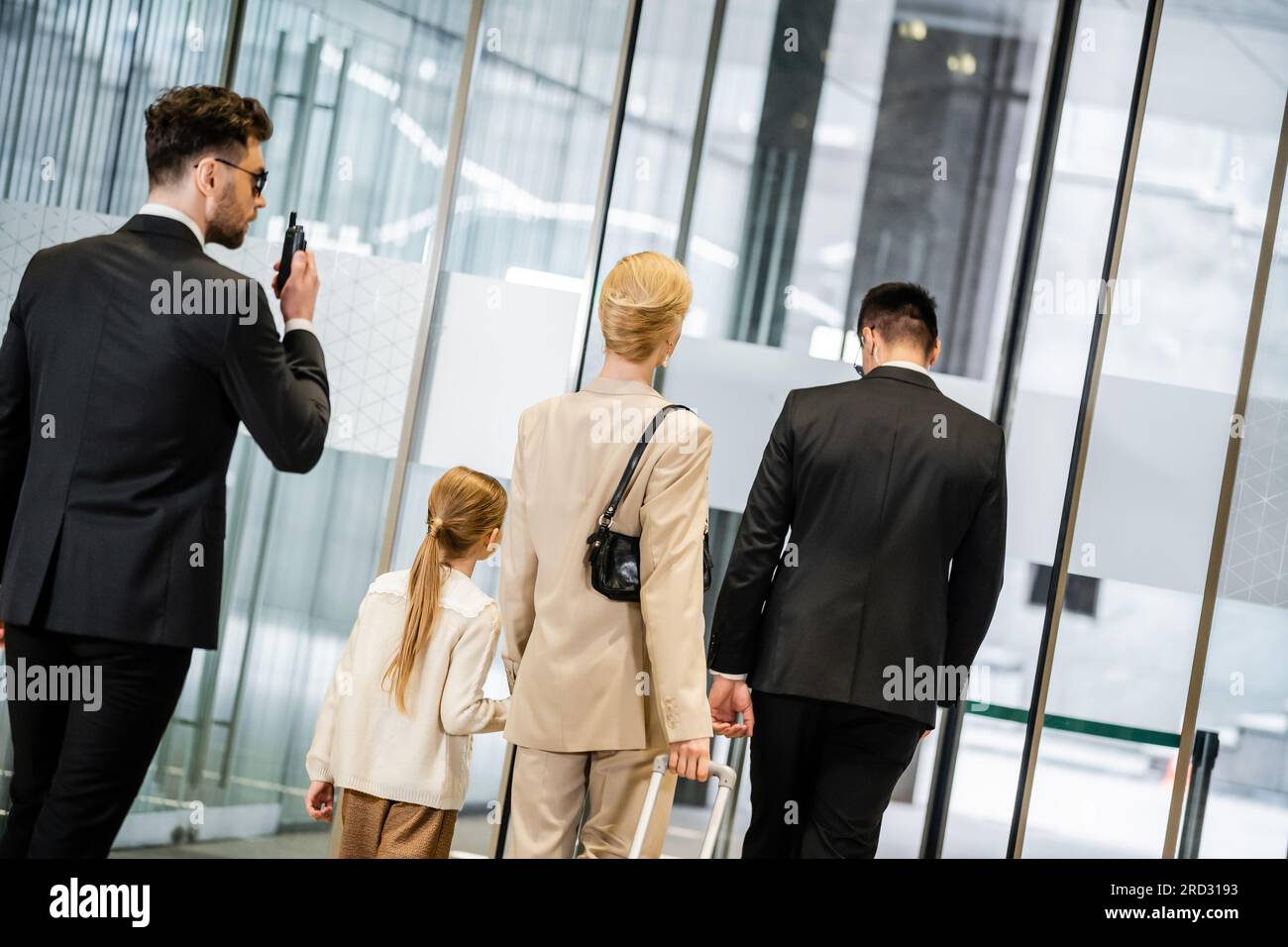 personal security concept, bodyguard in suit using radio transceiver ...