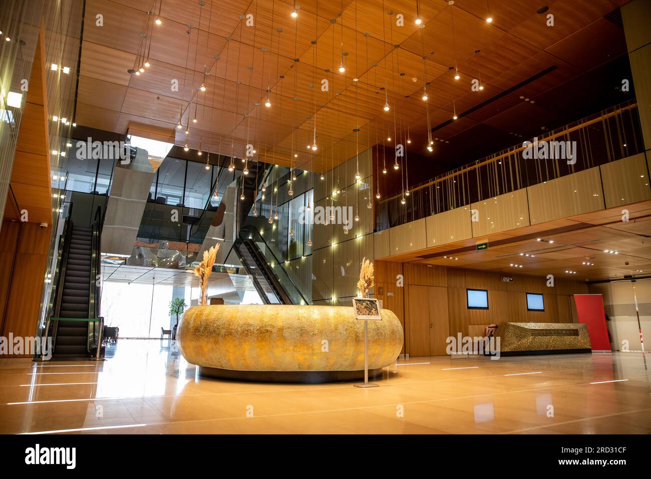 modern hotel interior with round reception desk and sophisticated lobby ...