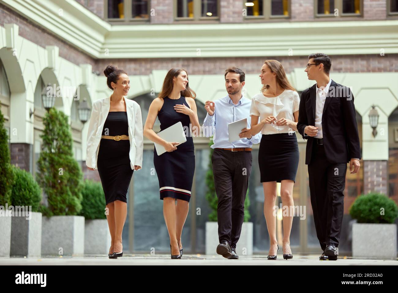Group of people, colleagues, employees standing outside the office ...