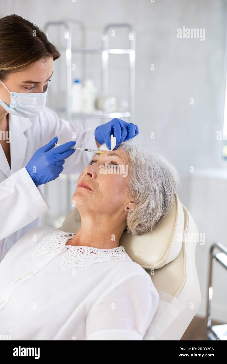 Facial injection mature patient Stock Photo - Alamy