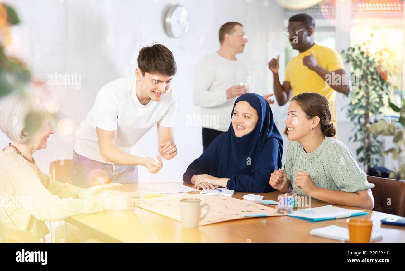 Group of multinational people playing board game Stock Photo - Alamy