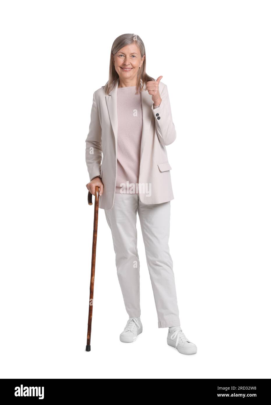 Senior woman with walking cane showing thumb up on white background ...