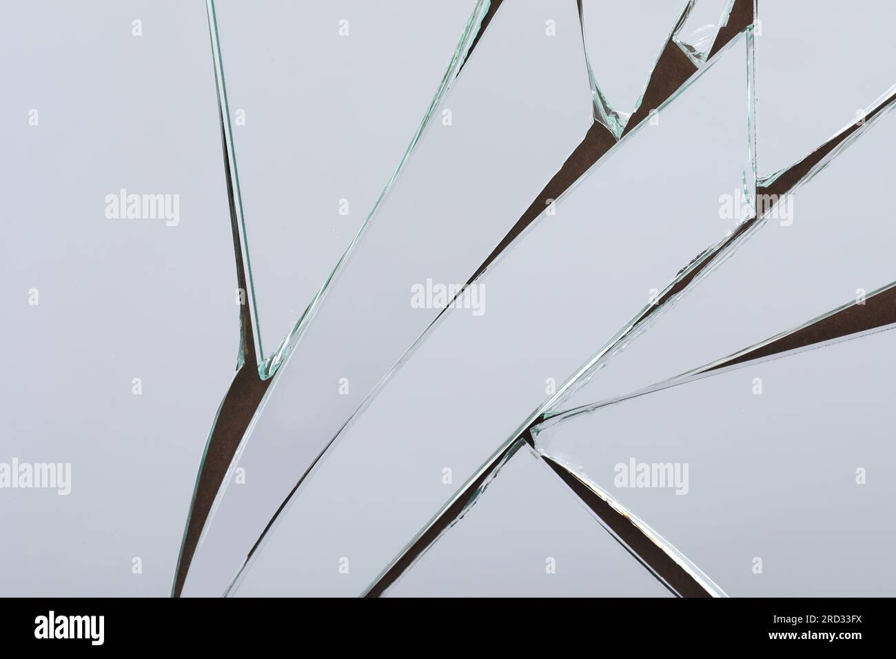 Shards of broken mirror on backing board, top view Stock Photo - Alamy
