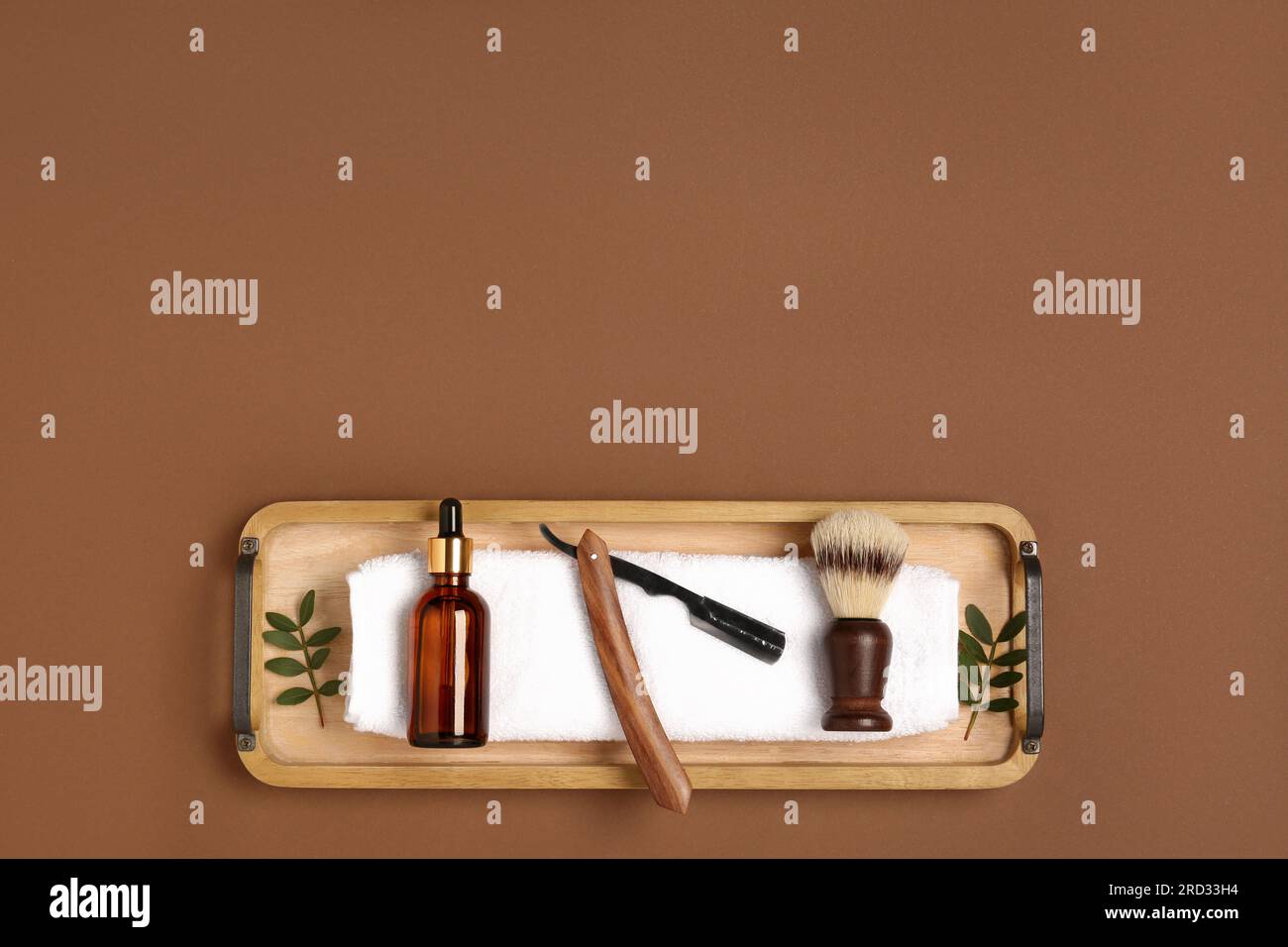 Set of men's shaving tools on brown background, top view. Space for ...