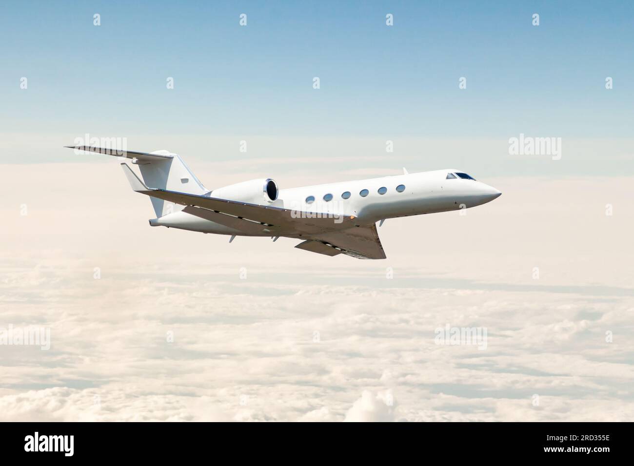 White luxury private jet flying in the air above the clouds Stock Photo ...