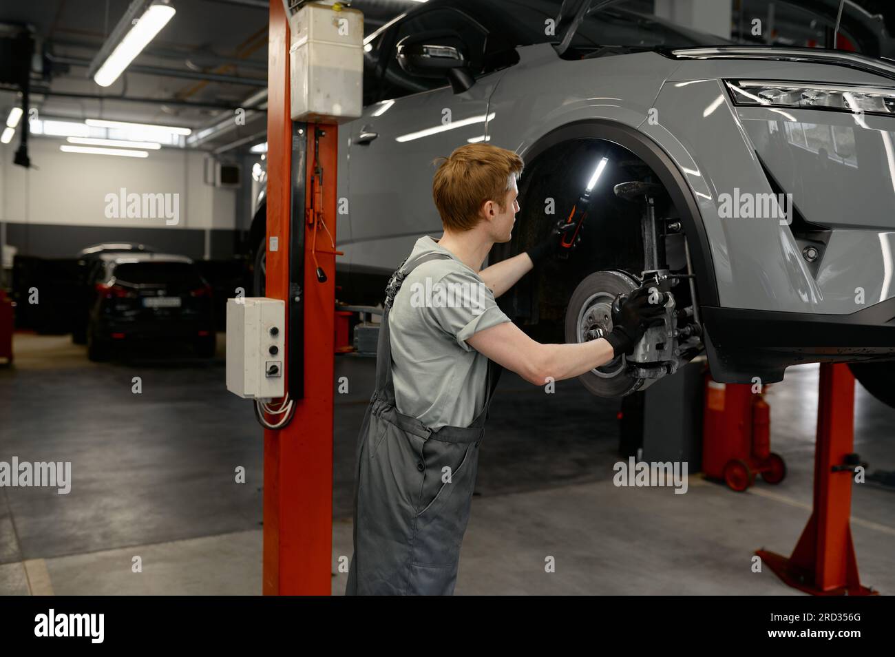 Professional auto mechanic working on car Stock Photo - Alamy