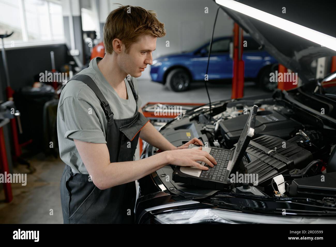 Mechanic providing computer diagnostics to find cause of car failure ...