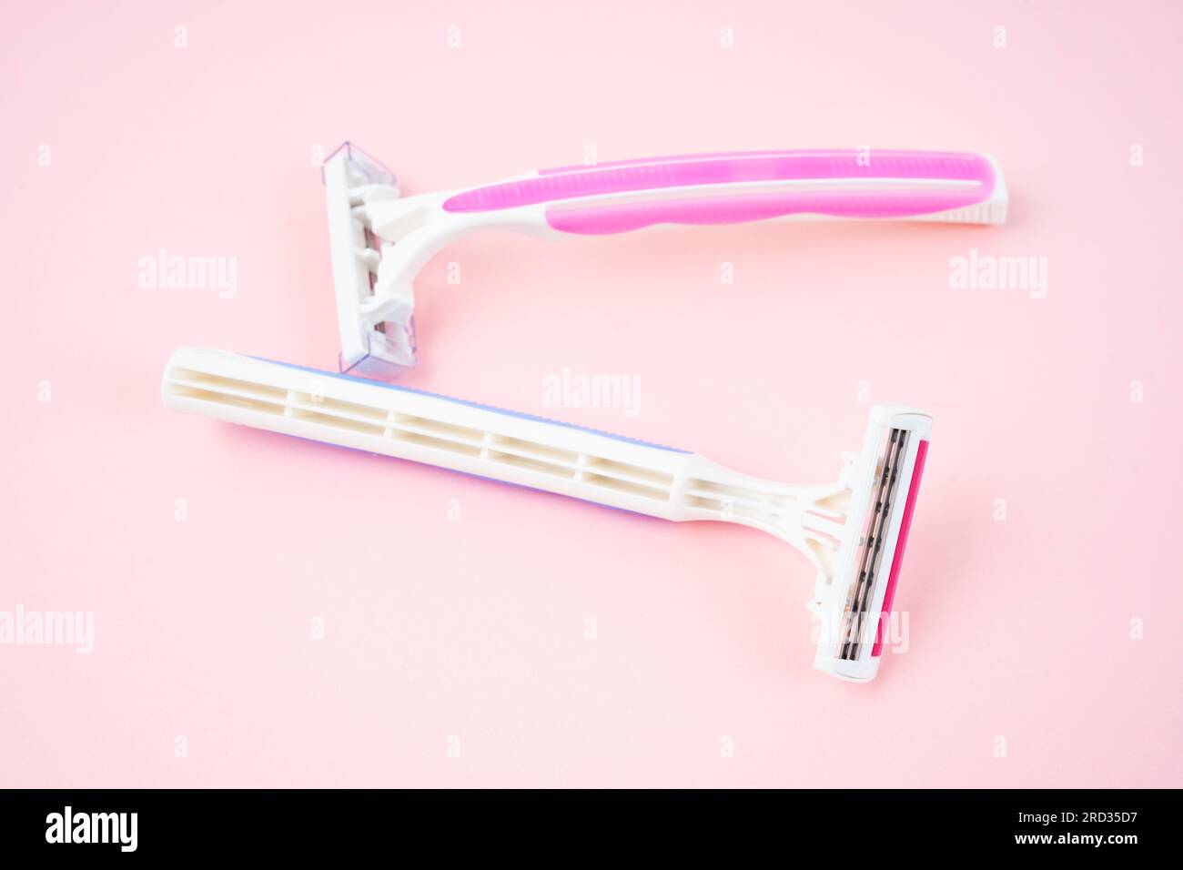 Two plastic, disposable razors on pink color background Stock Photo - Alamy