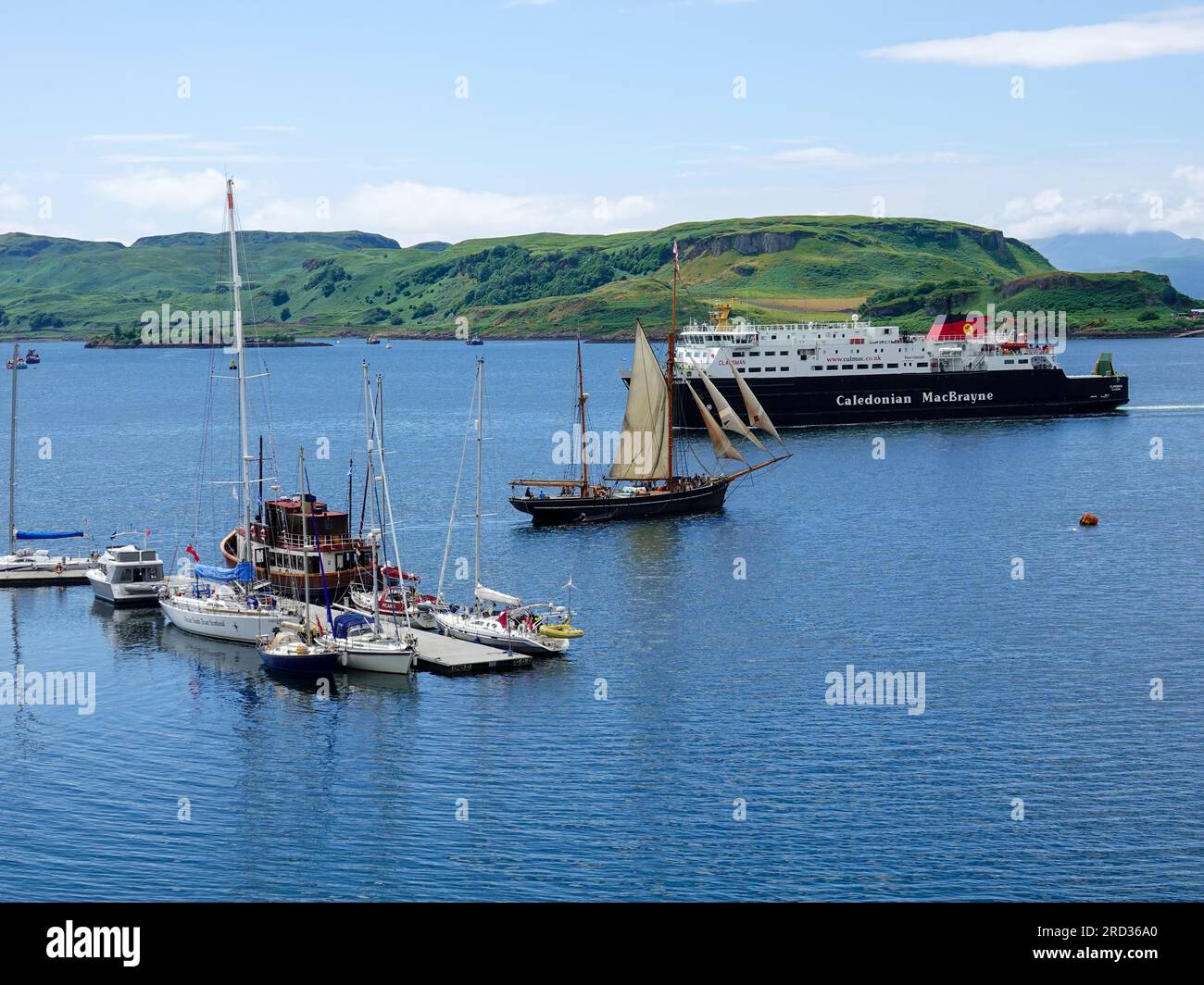 The tall ship Bessie Ellen, sailing past a CalMac ferry, as it departs ...