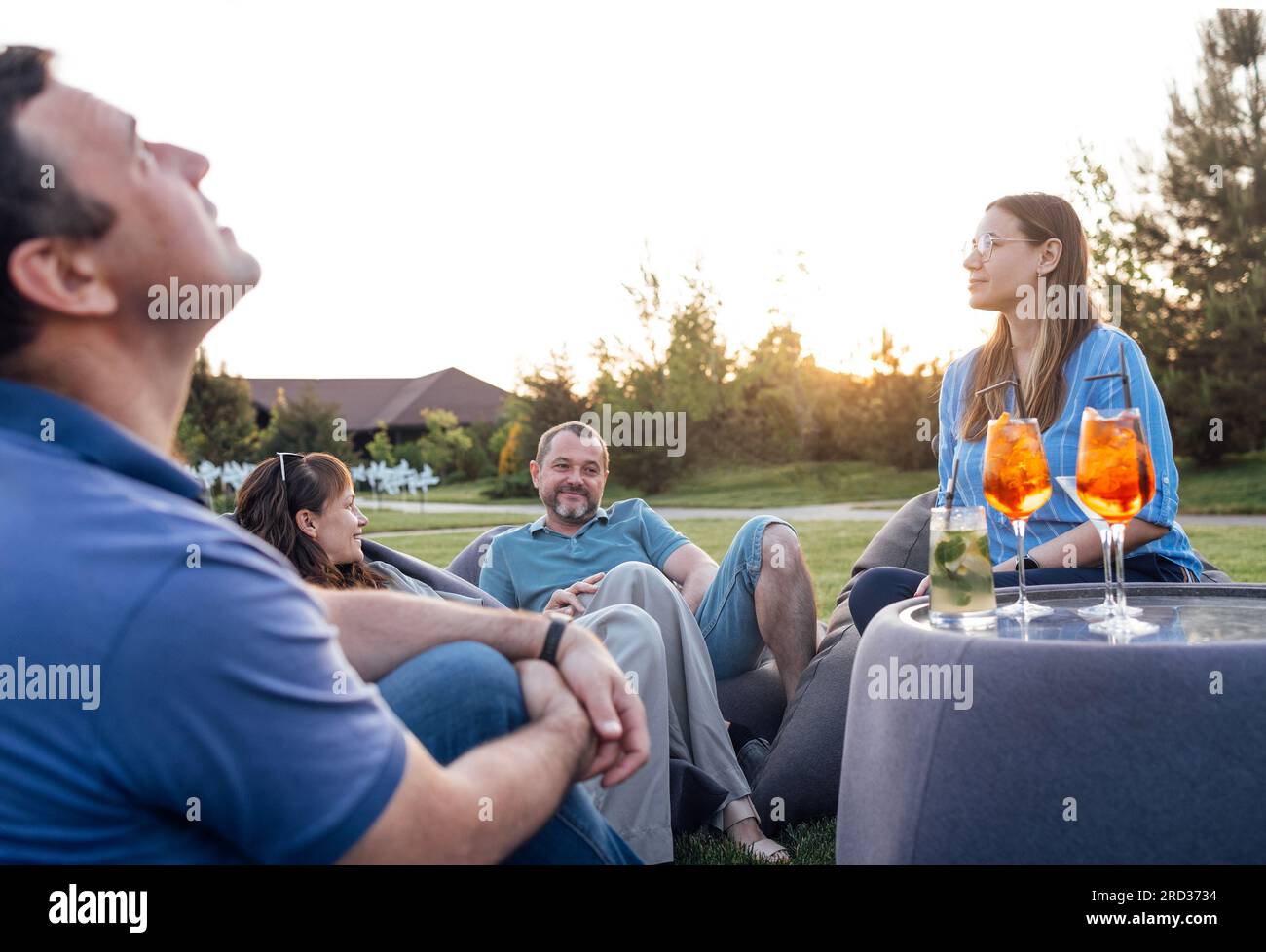Meeting friends in the backyard of the house or in open air cafe. A man ...