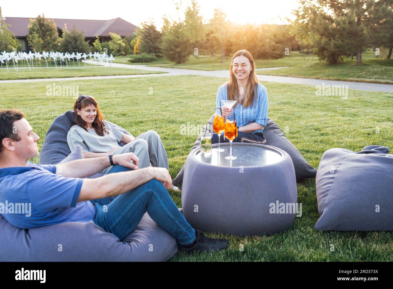 Meeting friends in the backyard of the house or in open air cafe. A man ...