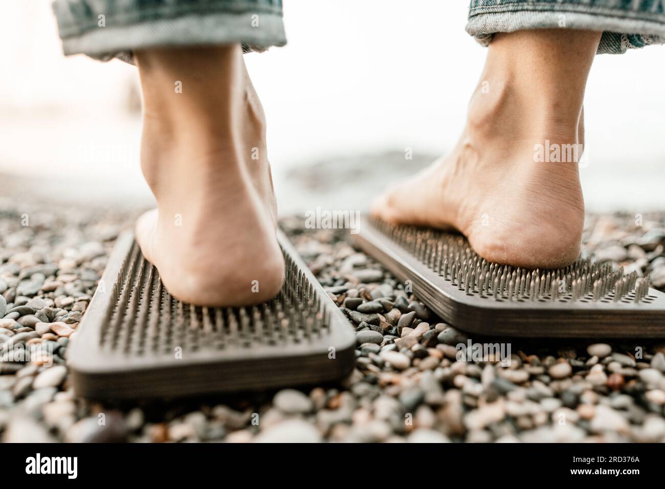 Sea Woman feet stepping on sadhu board during indian practice on the ...