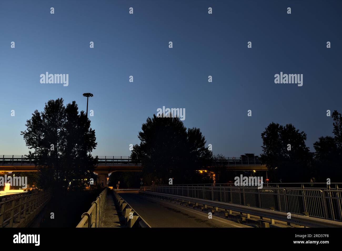 Lane on a bridge next to a viaduct in the italian countryside at night ...