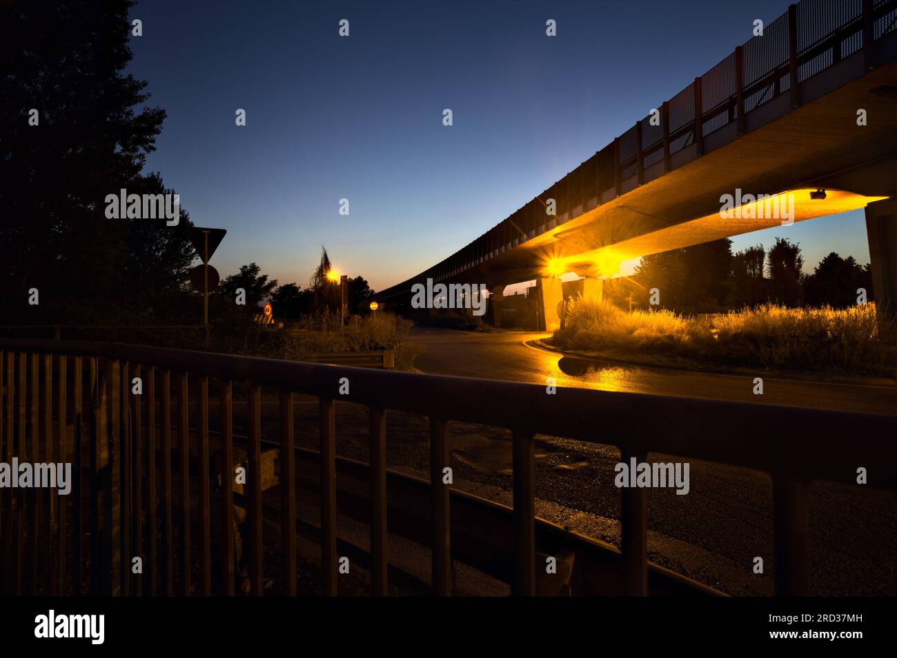 Roundabout under a viaduct in the italian countryside at night seen ...