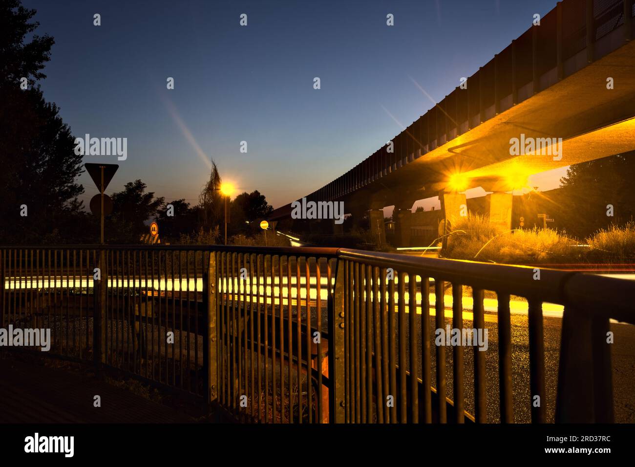 Roundabout under a viaduct in the italian countryside at night seen ...