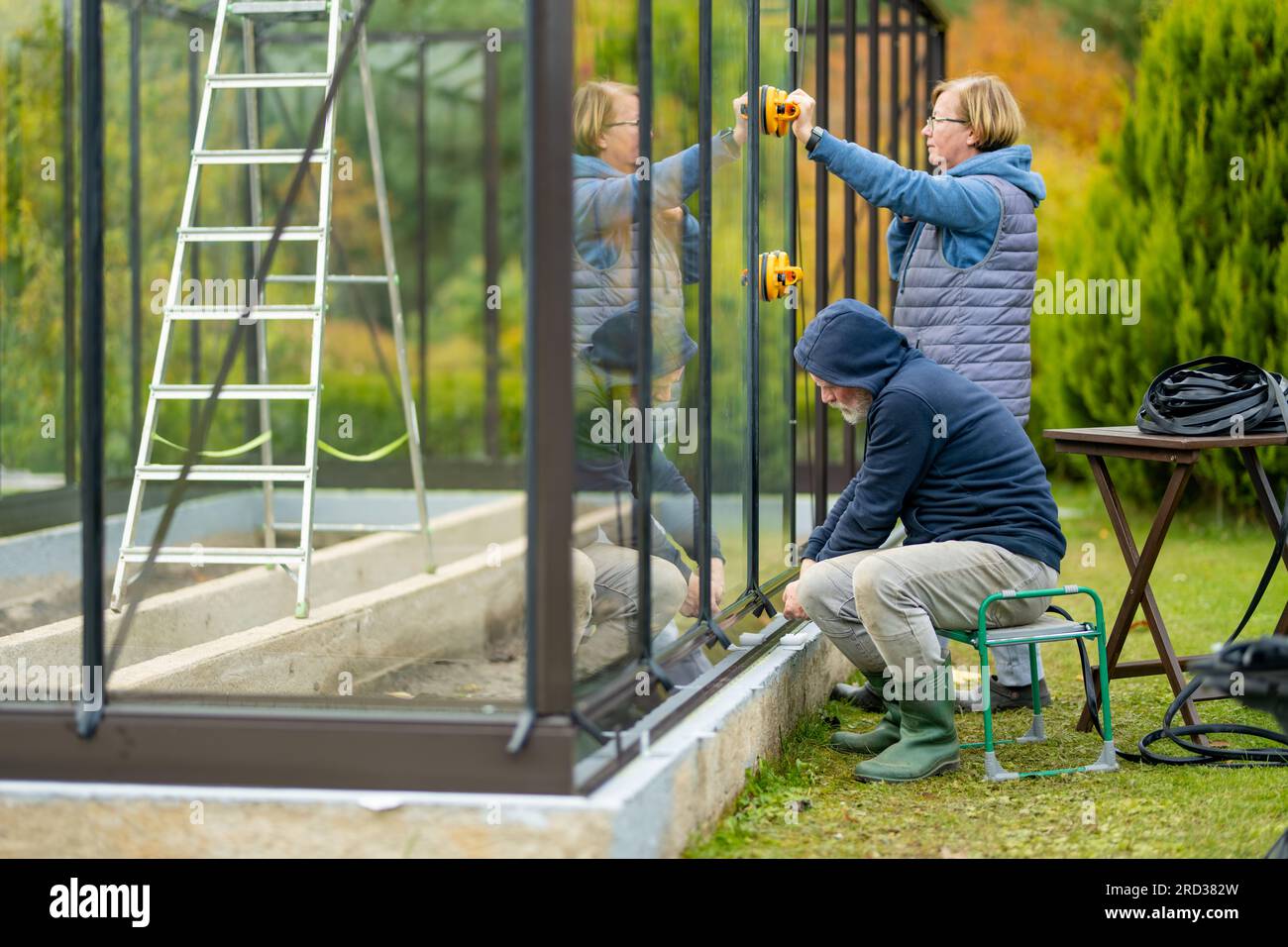 Senior couple working on a project in their garden. Man and woman ...