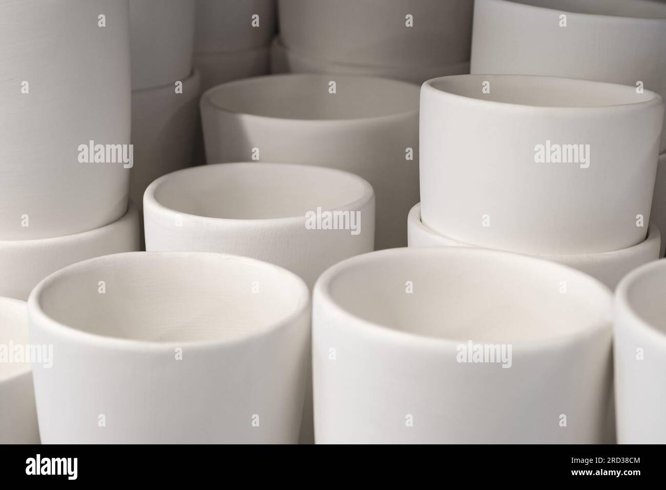 Big group of simple plain white unpainted porcelain cups, abstract ...