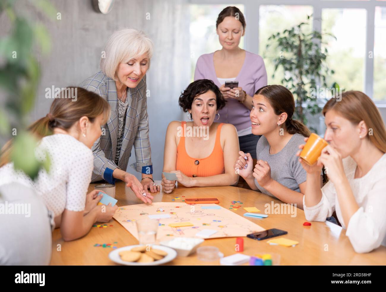 Group of of different years people playing tabletop game Stock Photo ...