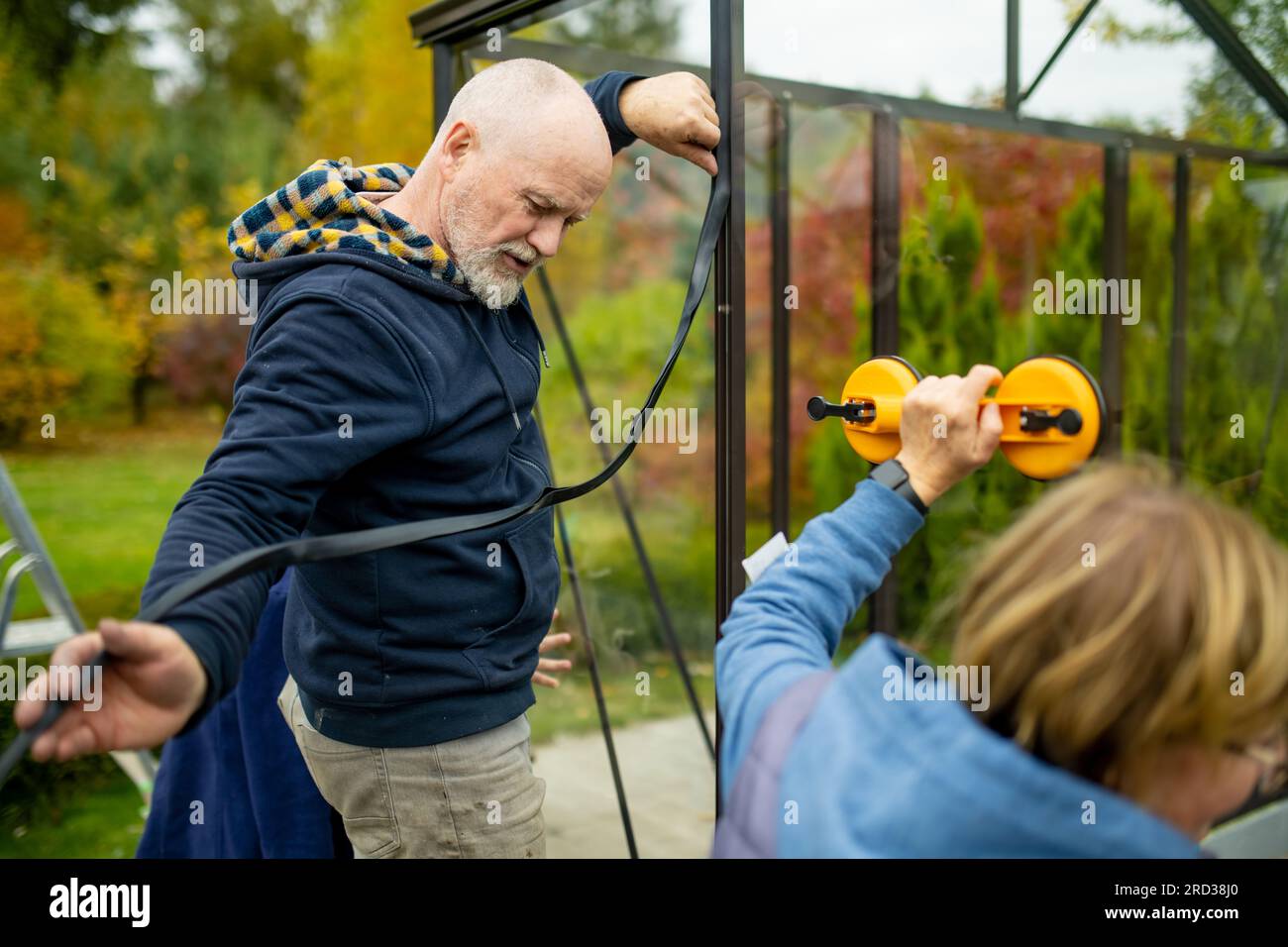 Senior couple working on a project in their garden. Man and woman ...