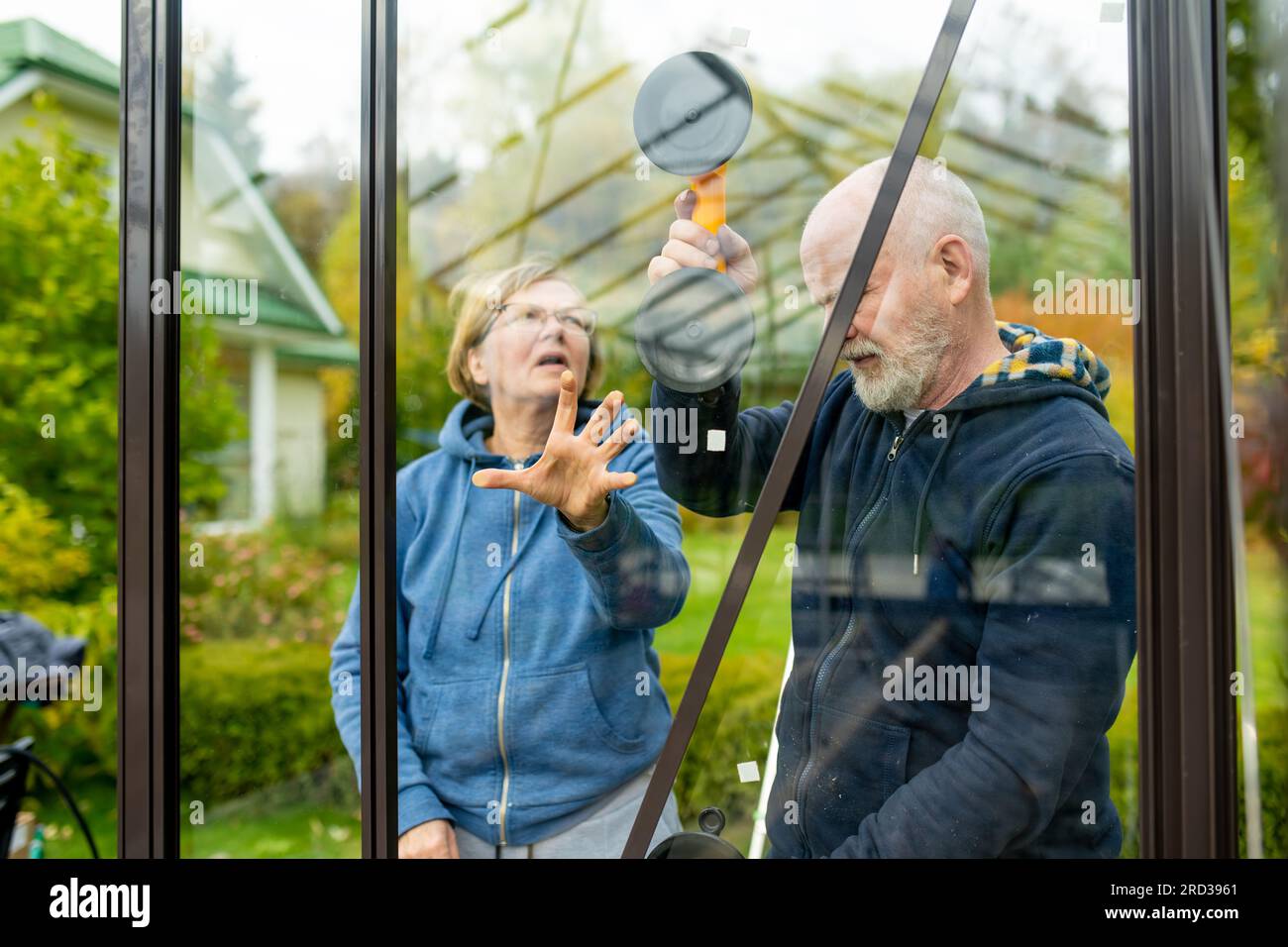 Senior couple working on a project in their garden. Man and woman ...