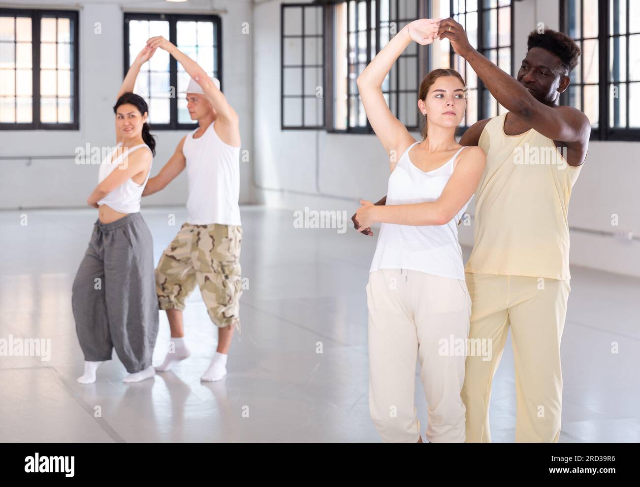 People dancing twist in pairs in studio Stock Photo - Alamy