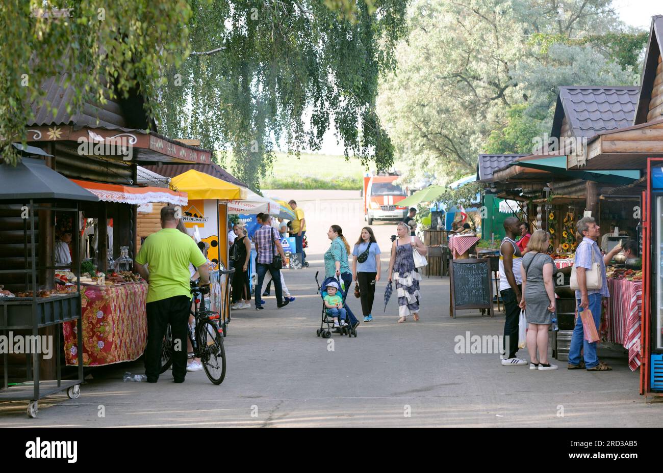 People visitors walking aroung street food stalls and souvenir stalls ...