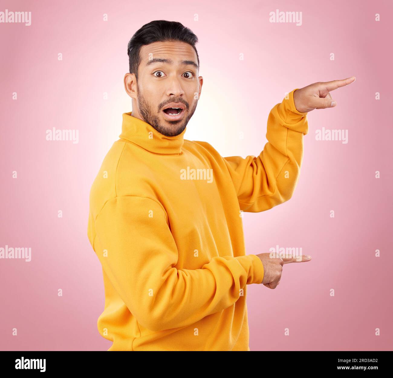 Surprise, pointing and wow with portrait of man in studio for show ...