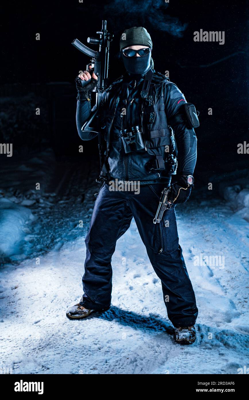 Strong man military special forces standing with guns on snow at night ...