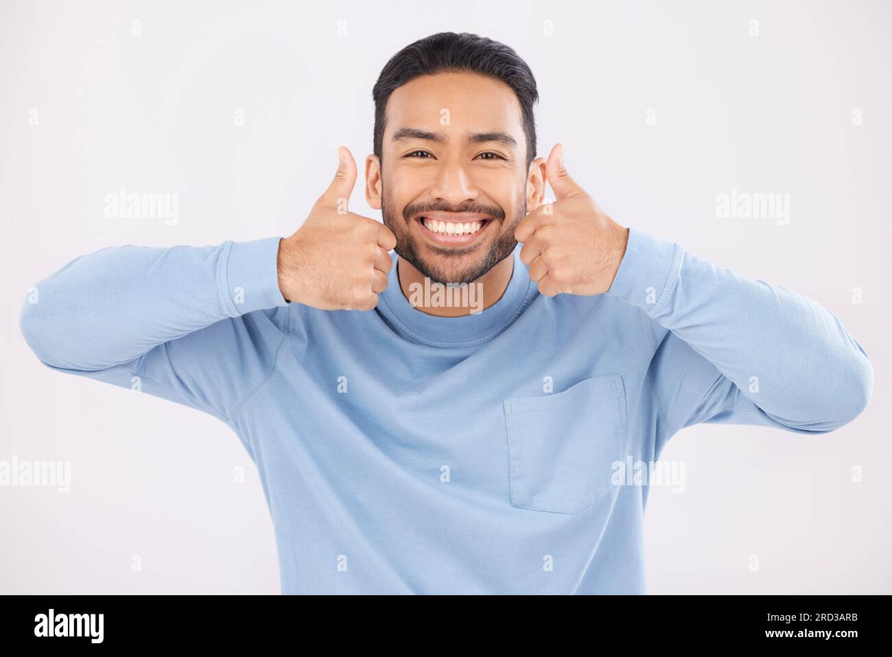 Portrait, thumbs up and man in studio happy with hand, sign and thank ...