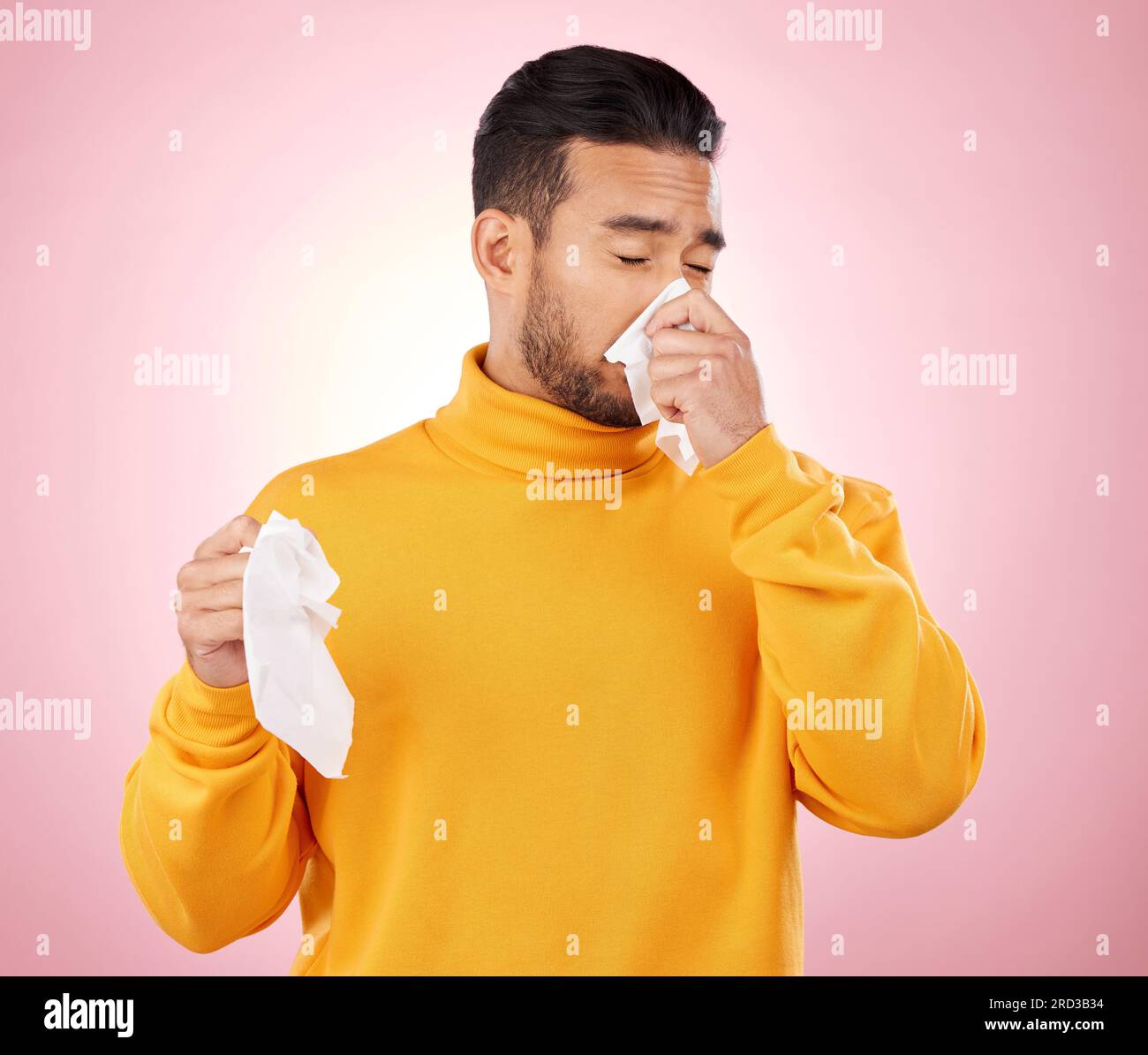 Sick, tissues and man blowing his nose in a studio with a cold, flu or ...