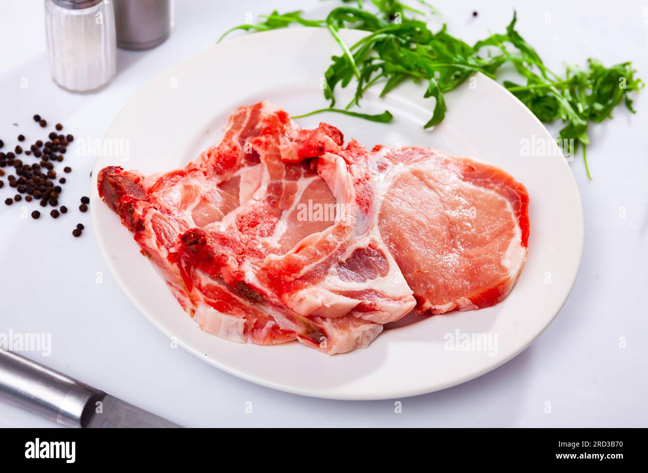 Uncooked pork loins over white background Stock Photo - Alamy