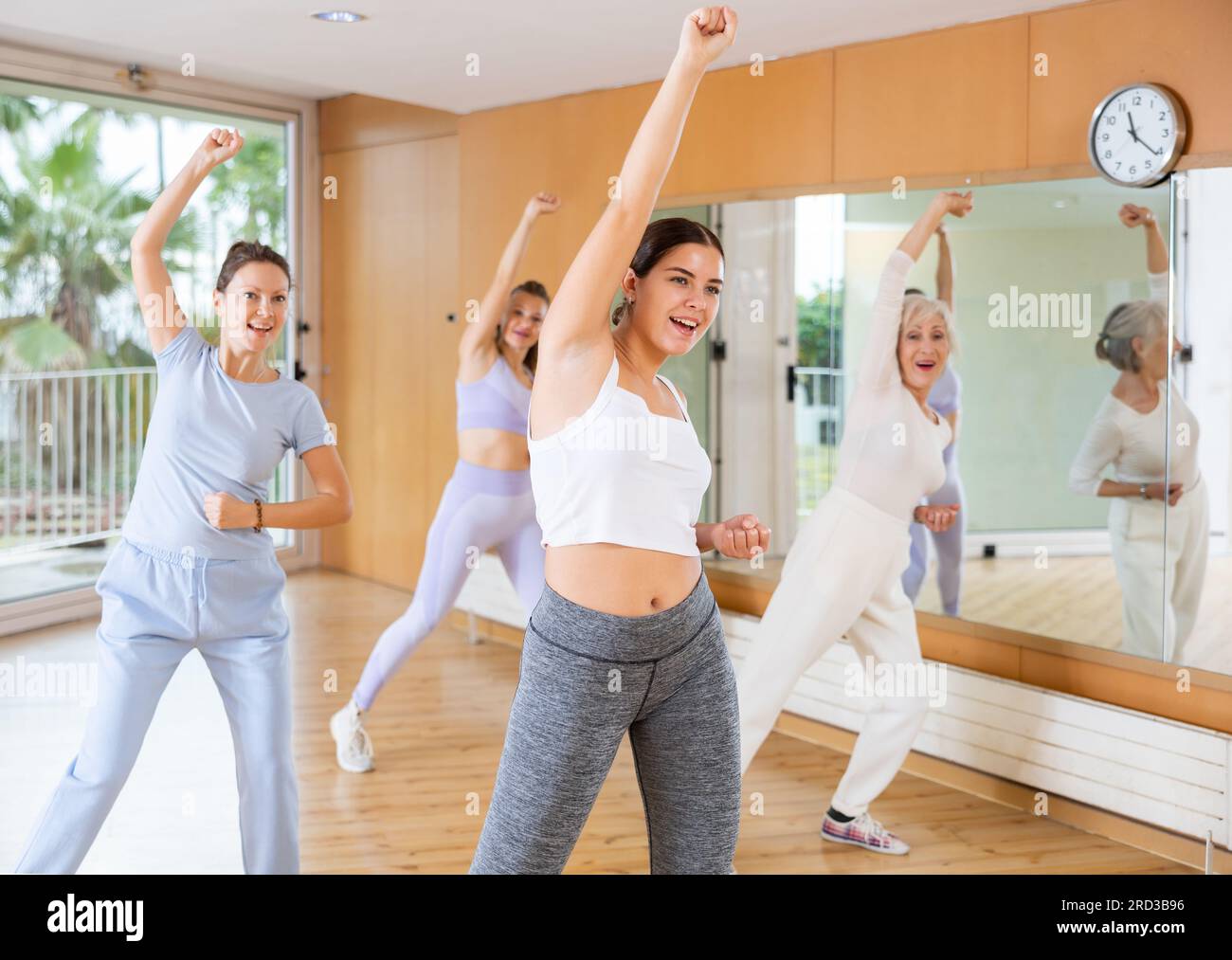 Active young woman practicing aerobic dance in training hall Stock ...