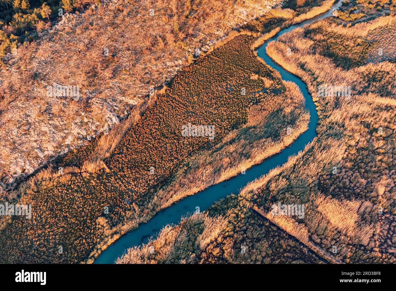 aerial view of a river stream winding through lush wetlands. The image ...