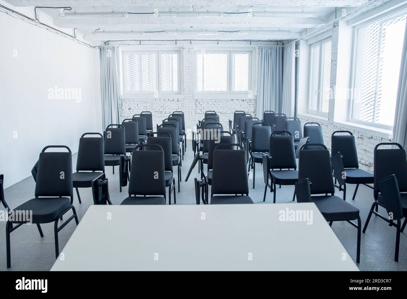 Clear conference room, classroom. White brick wall Stock Photo - Alamy